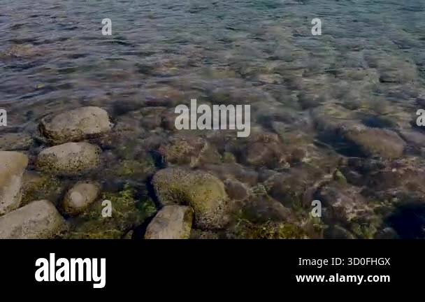 Crystal clear Mediterranean Sea water with visible rocky seabed ...