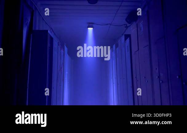 Cinematic shot of foggy corridor illuminated by flickering blue light ...