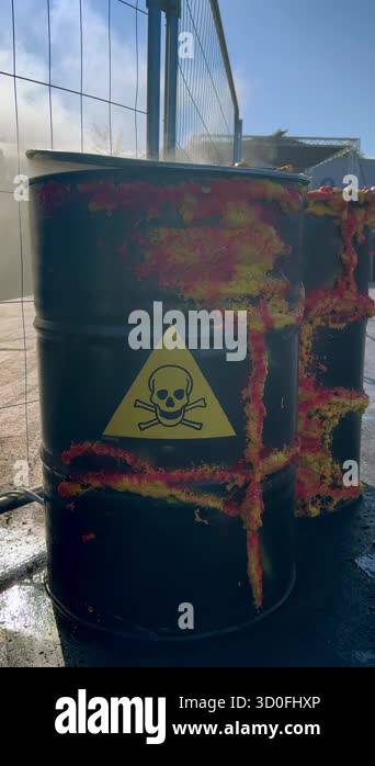 Close-up of toxic barrels with skull warning sign and glowing slime ...
