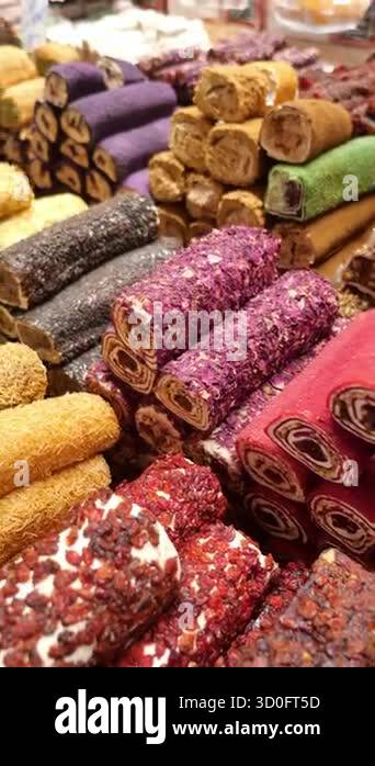 A vibrant display of various traditional sweets at a market stall Stock ...