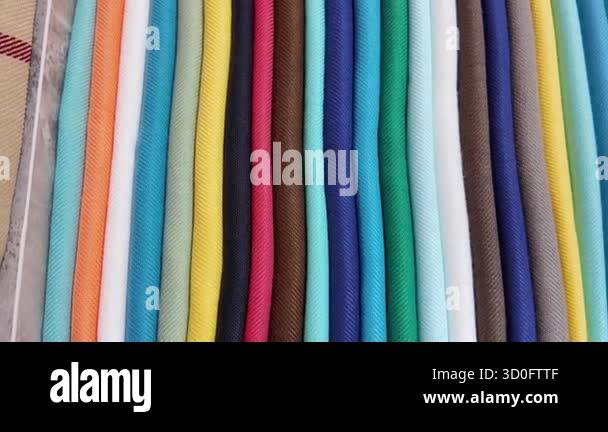 Brightly colored fabric rolls showcased in a shop setting Stock Video ...