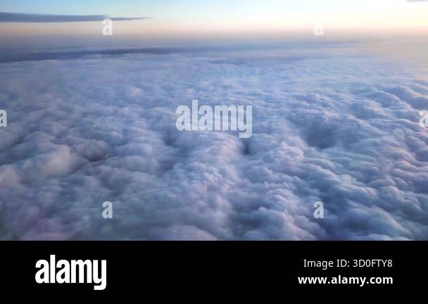 Endless fluffy clouds stretch across the sky at sunset Stock Video ...
