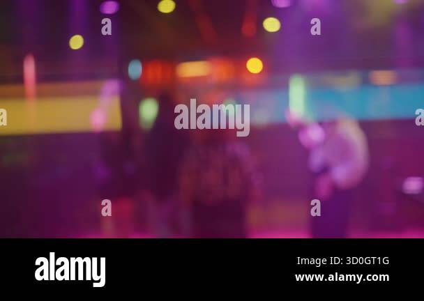 blurred neon club scene with bokeh lights and hazy silhouettes of ...