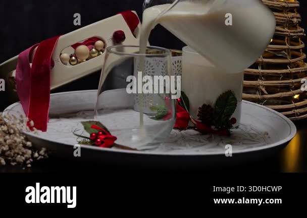 Preparing a delicious homemade rompope drink in a glass for christmas ...