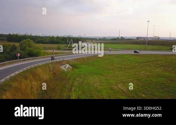 Motorcyclist riding a chopper motorcycle on a scenic country road at ...