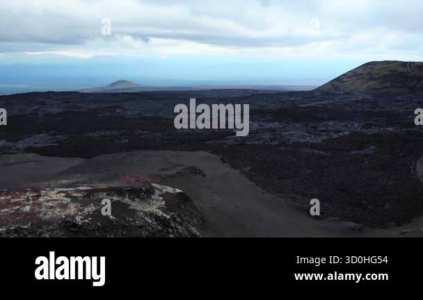 Aerial footage of a vast, desolate lava field landscape in iceland ...