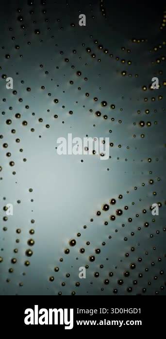 Golden spheres create a mesmerizing visual effect, rotating and forming ...