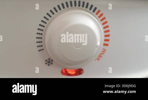 Regulator for heating water in home boiler. Man turns temperature ...