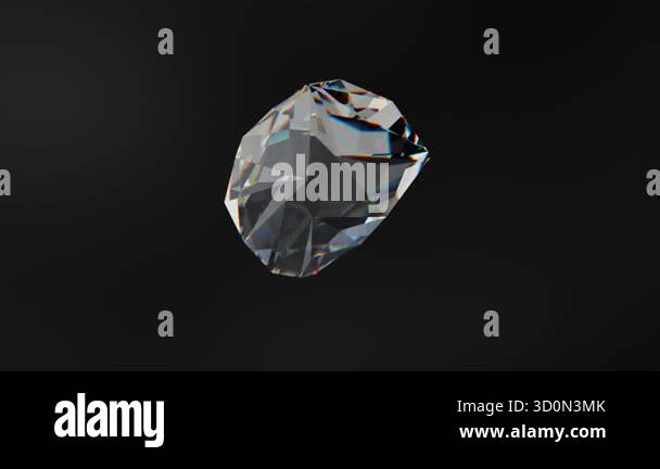 A brilliant diamond rotating on a pitch black background catches the ...