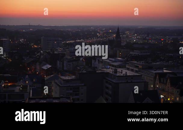 Fiery sunset above city. Video captures a vibrant orange-red sunset ...
