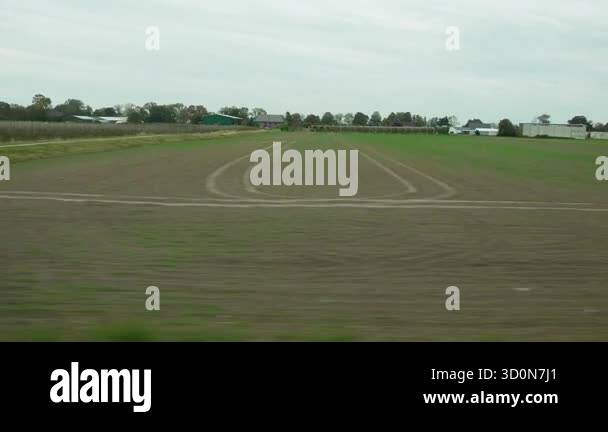 Rural Farmland and Buildings. A peaceful scene of green farmland and ...