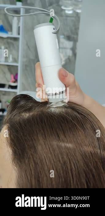 Woman with hair loss undergoing scalp analysis at trichologist. Close ...