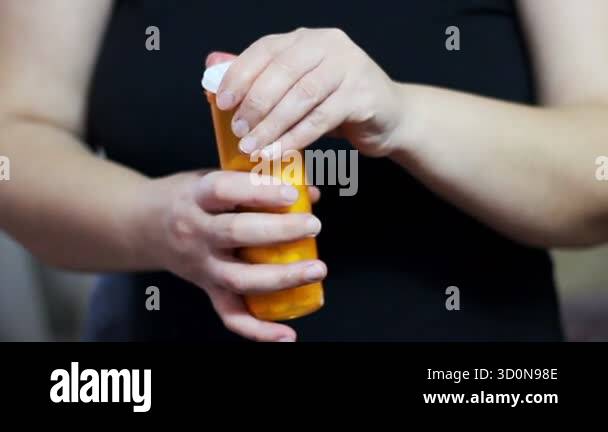 woman taking white medical pills from orange box. Dumping drugs ...