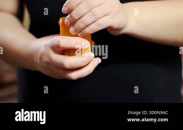 woman taking white medical pills from orange box. Dumping drugs ...