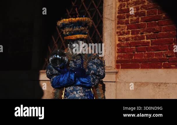 Venice, Italy FEBRUARY, 3, 2024 A person in bright shiny costume and ...