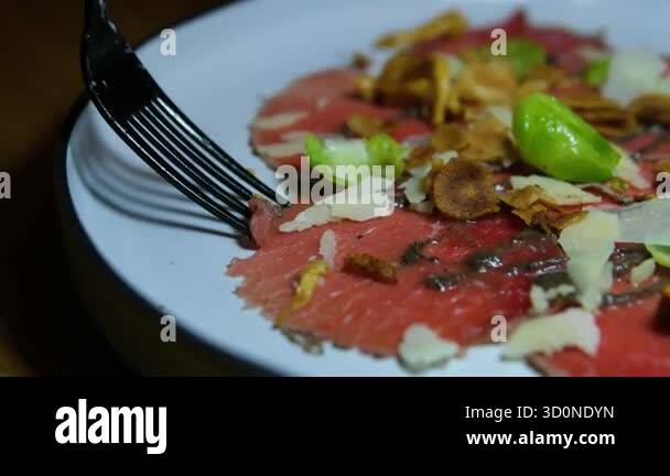 Traditional italian beef carpaccio garnished with parmesan and ...