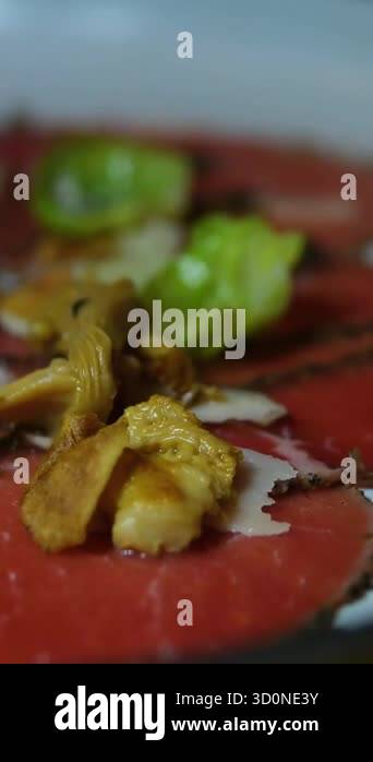 Authentic italian beef carpaccio decorated with parmesan and ...