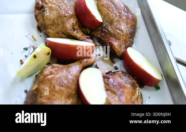 Homemade cooking process of duck legs with apples. Hands of young woman ...
