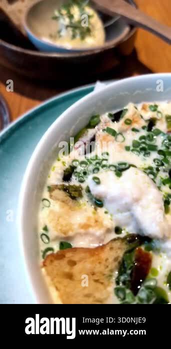 Vertical 4K footage of traditional Norwegian fish soup, creamy broth ...