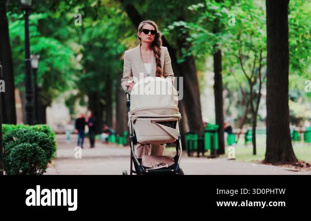 Elegant woman in sunglasses walking confidently through a tree lined ...