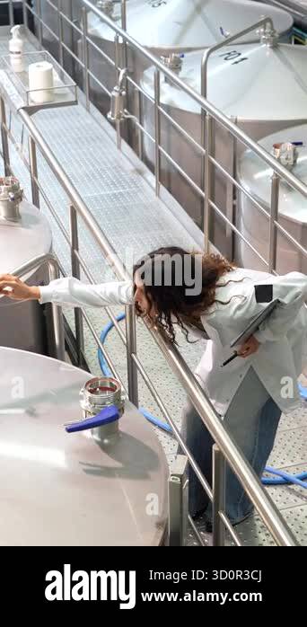 Knowledgeable woman in a lab coat walking along a catwalk, meticulously ...