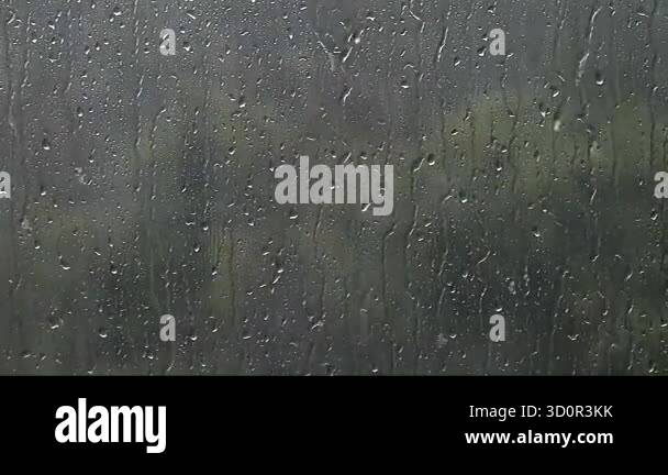 Footage of raindrops hitting window's glass during a heavy rain Stock ...