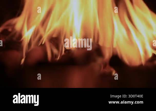 Fiery wood logs with high dancing flames and vertical heat waves in ...