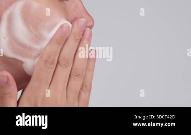 Close-up of an unrecognizable woman washing face with cleansing foam on ...