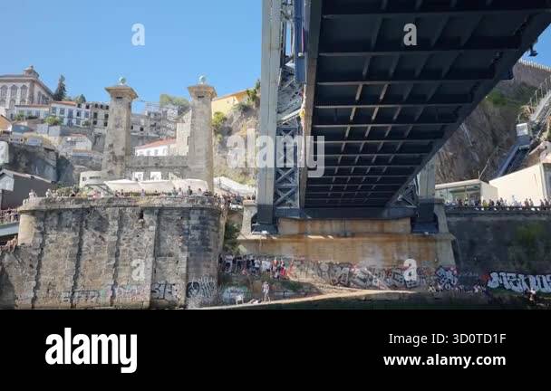 Porto, Portugal - 11 August, 2023: People jumping from the Dom Luis ...