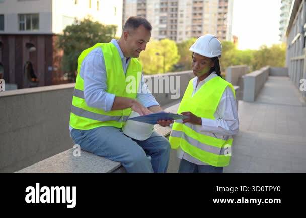 Construction workers discussing building Stock Videos & Footage - HD ...