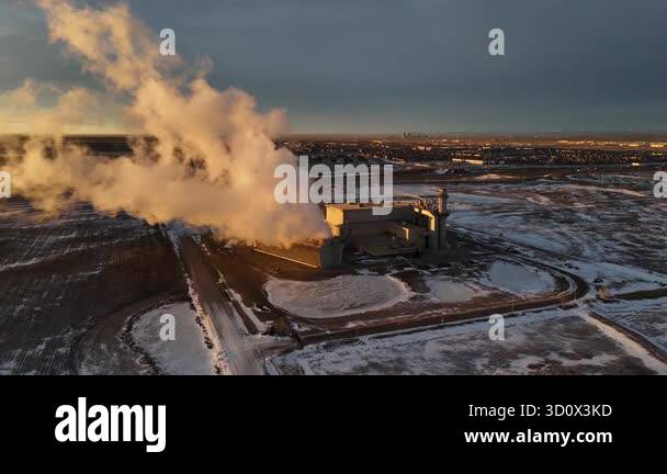 Sunrise rotating aerial steam rising of gas fire power plant ...