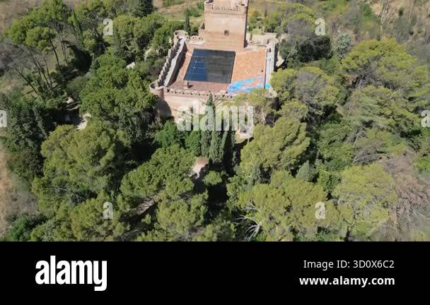 Aerial top-down view flying over an abandoned castle with modern solar ...