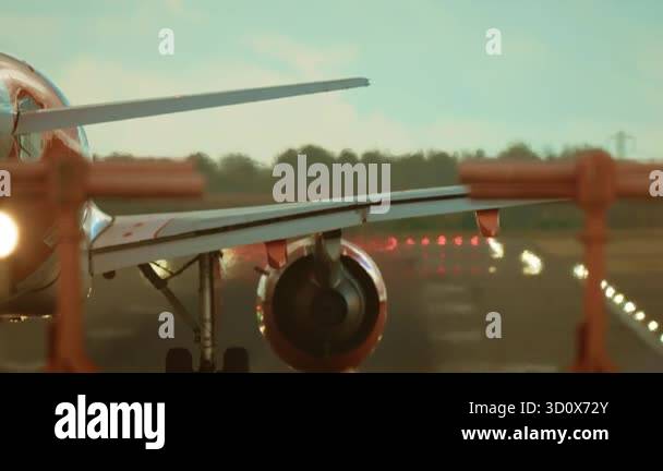 Jetliner warming turbines and beginning takeoff roll on runway ...