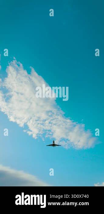 Jet flying overhead with wings spread wide and turbines generating ...