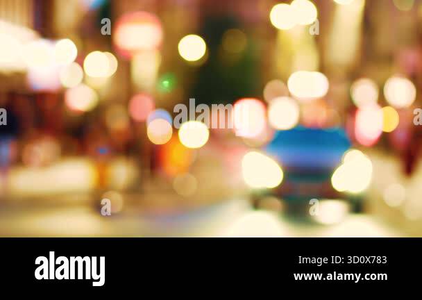 Bright blurred cars turning at city intersection with headlights on ...