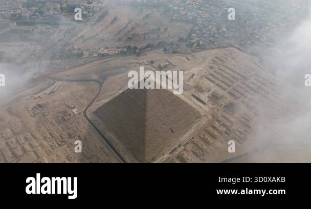Aerial view of the Giza Pyramids in Egypt beneath drifting clouds ...