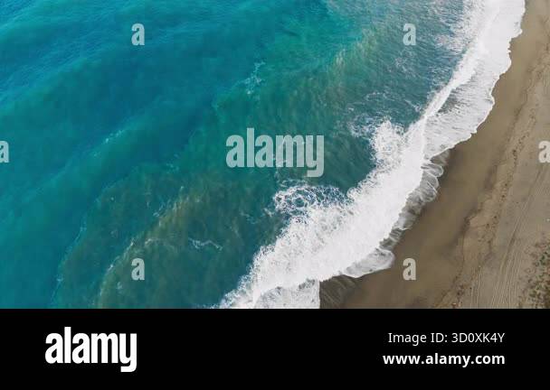 The Blue Ocean Water Color With Foam Of Waves On The Sandy Shore ...