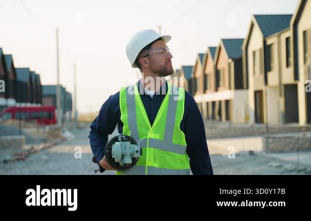 Smiling male telecom technician in uniform holding a fiber optic splice ...