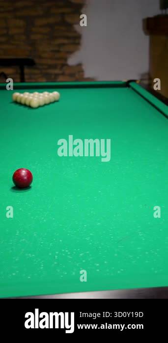 Player lining up a shot in a game of russian pyramid billiards, with ...