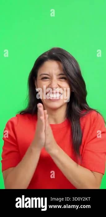 Ecstatic young woman clapping hands and celebrating against a chromakey ...