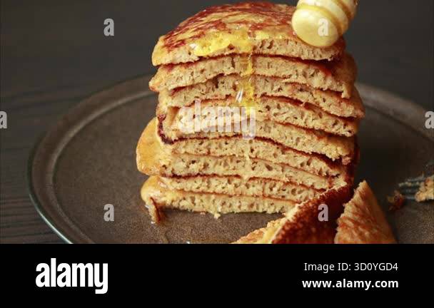 A stack of fluffy golden pumpkin pancakes topped with warm autumn ...