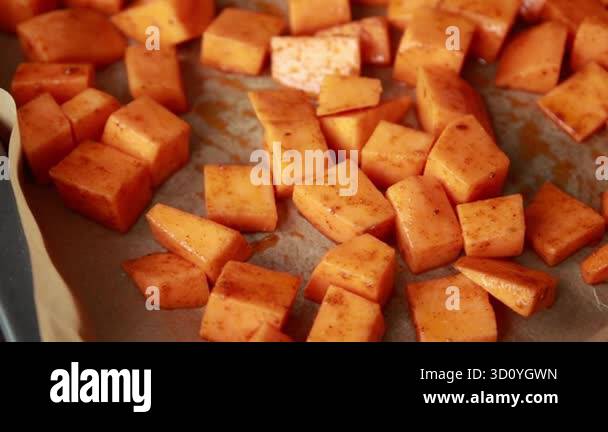 raw sweet potato cubes in tray ready to bake close up Stock Video ...