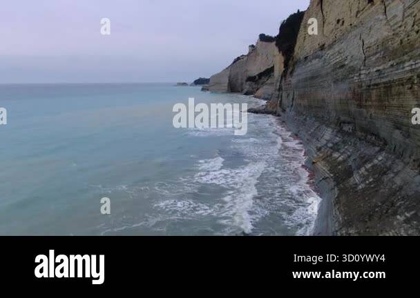 Cinematic drone footage flying along the immense layered cliffs of ...