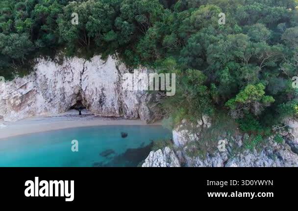 Aerial drone pan over a beautiful beach in Greece, showing people ...