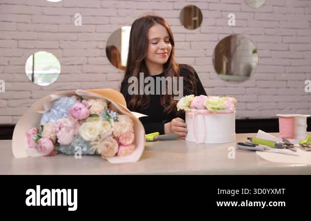A highly skilled florist is meticulously creating a stunningly ...