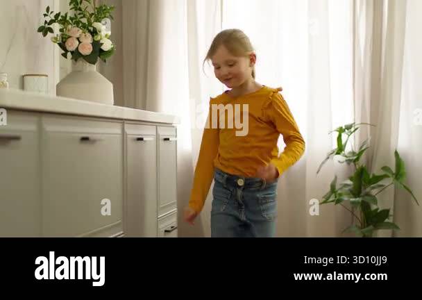 Happy Caucasian little girl kid child daughter dancing at home alone ...