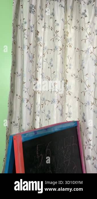 School-age boy studying at home, focused on doing homework with ...