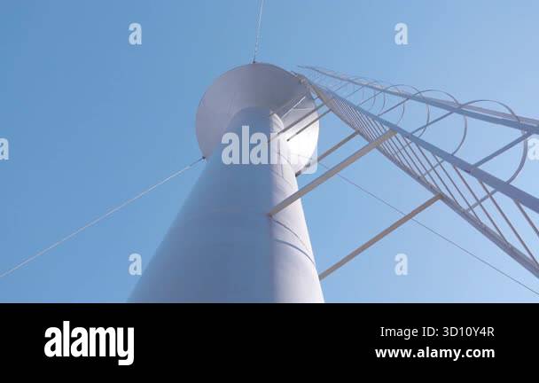 Water tower captured from a low angle, revealing intricate details and ...