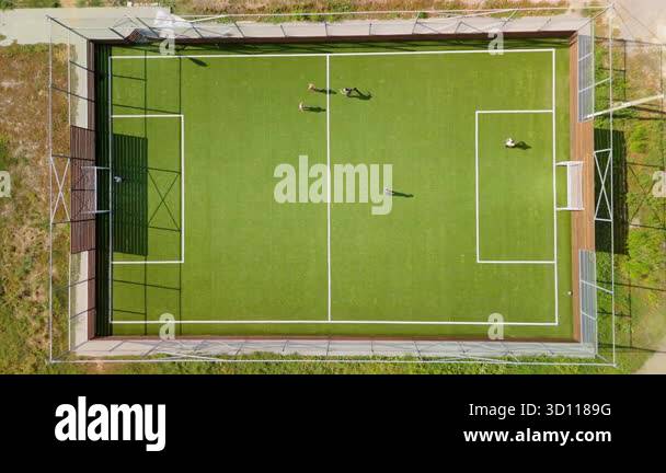 Aerial view of children playing football, illustrating their energetic ...
