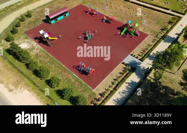 Aerial perspective captures lively playground scene with children engaging on slides and swings ...
